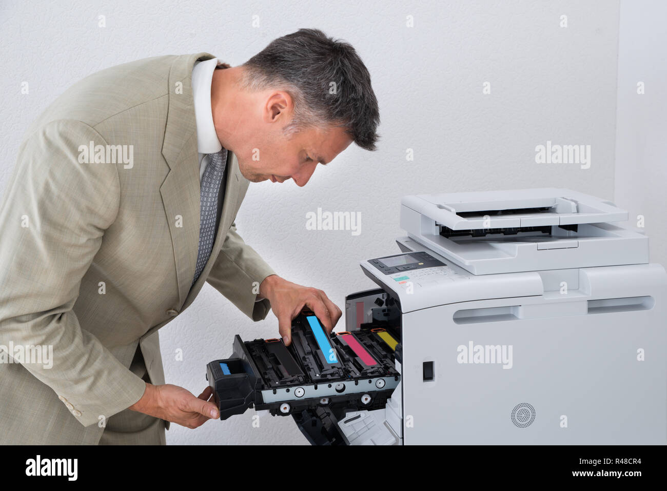 Mature Businessman Fixing Cartridge In Photocopy Machine Stock Photo ...