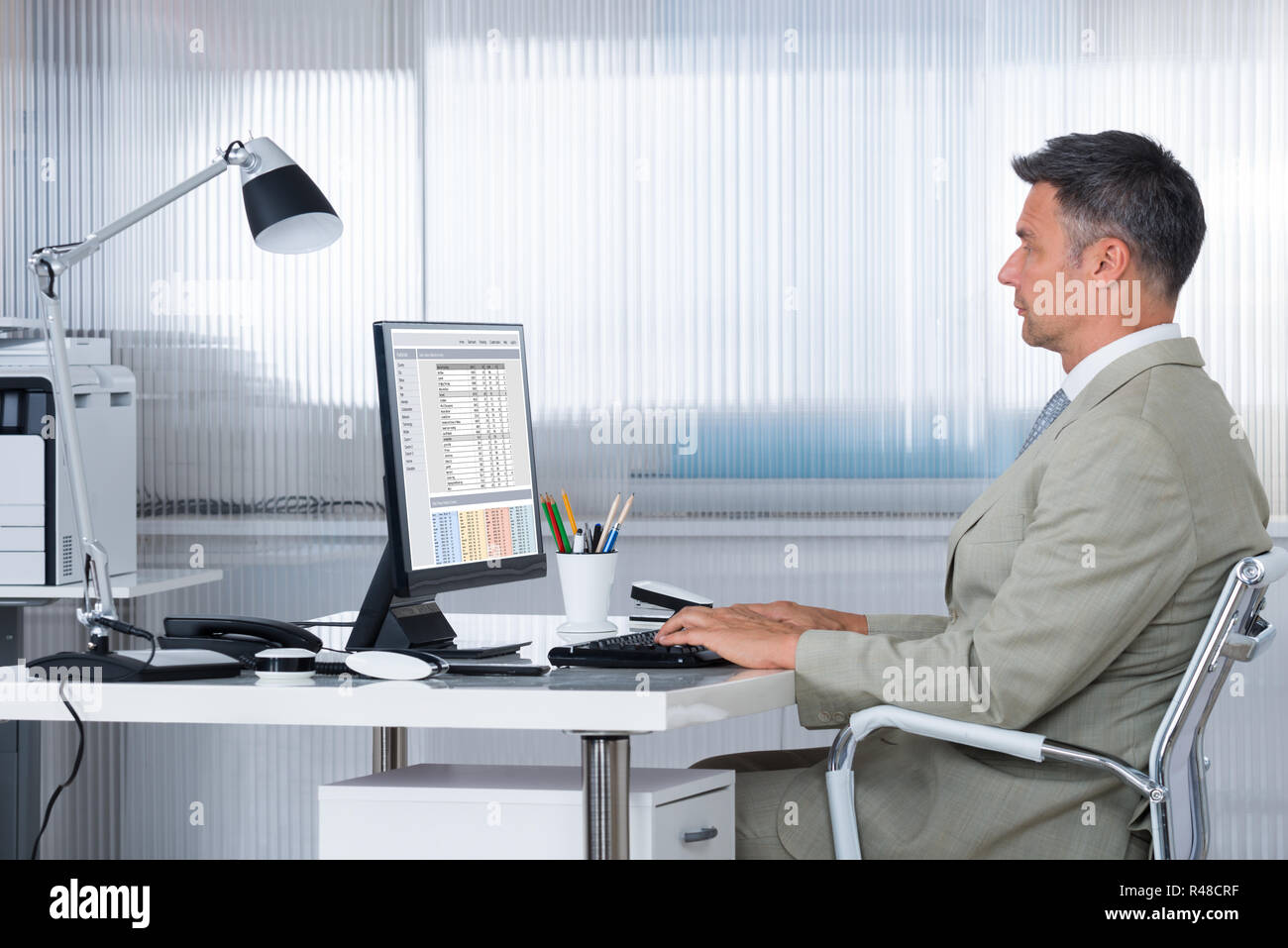 Male Accountant Using Computer At Desk Stock Photo - Alamy