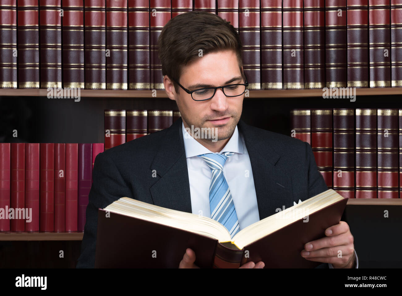 Advocate Reading Book At Courtroom Stock Photo - Alamy
