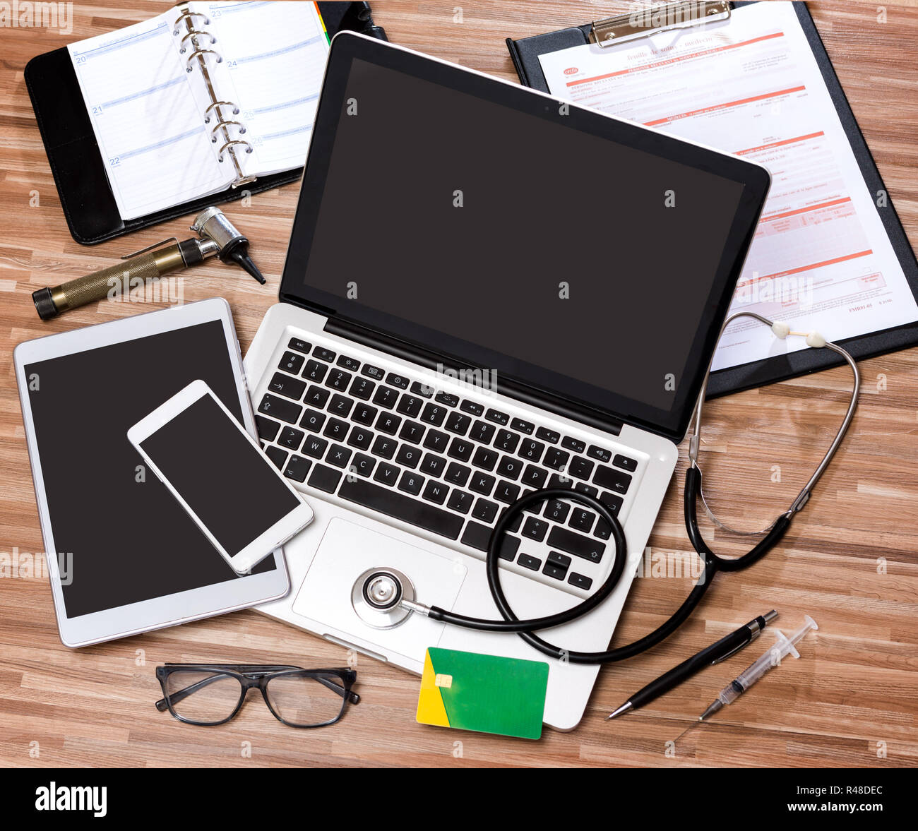 Wood doctor's desk in high definition with laptop, tablet and mobile ...