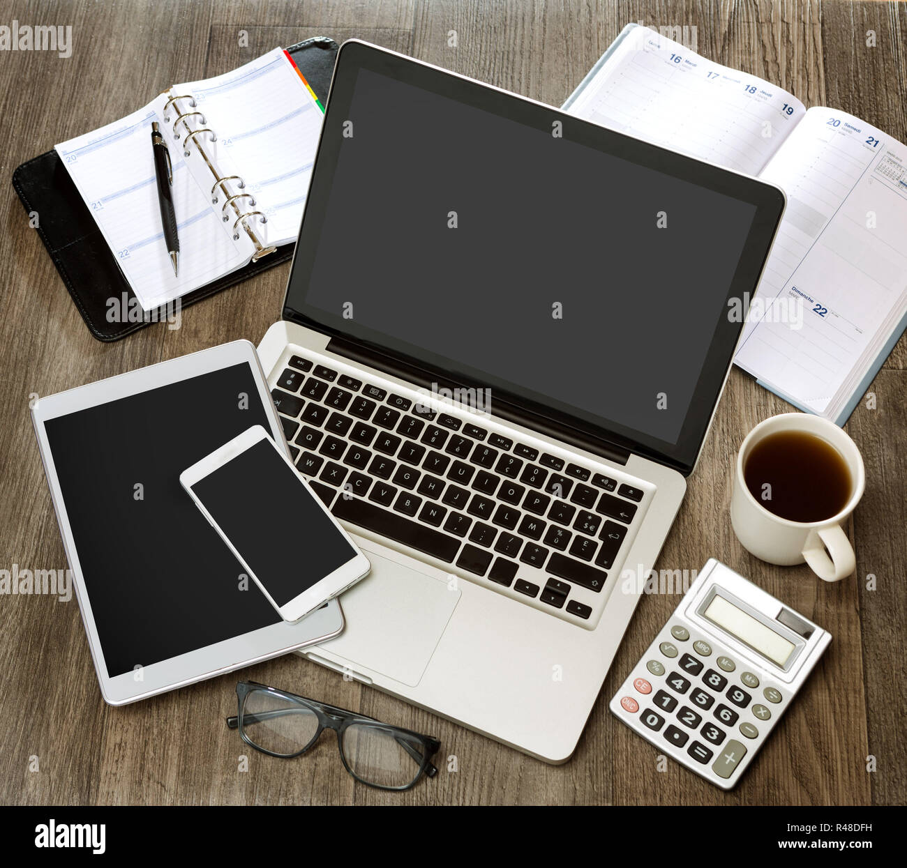 Wood businessman's desk in high definition with laptop, tablet and ...