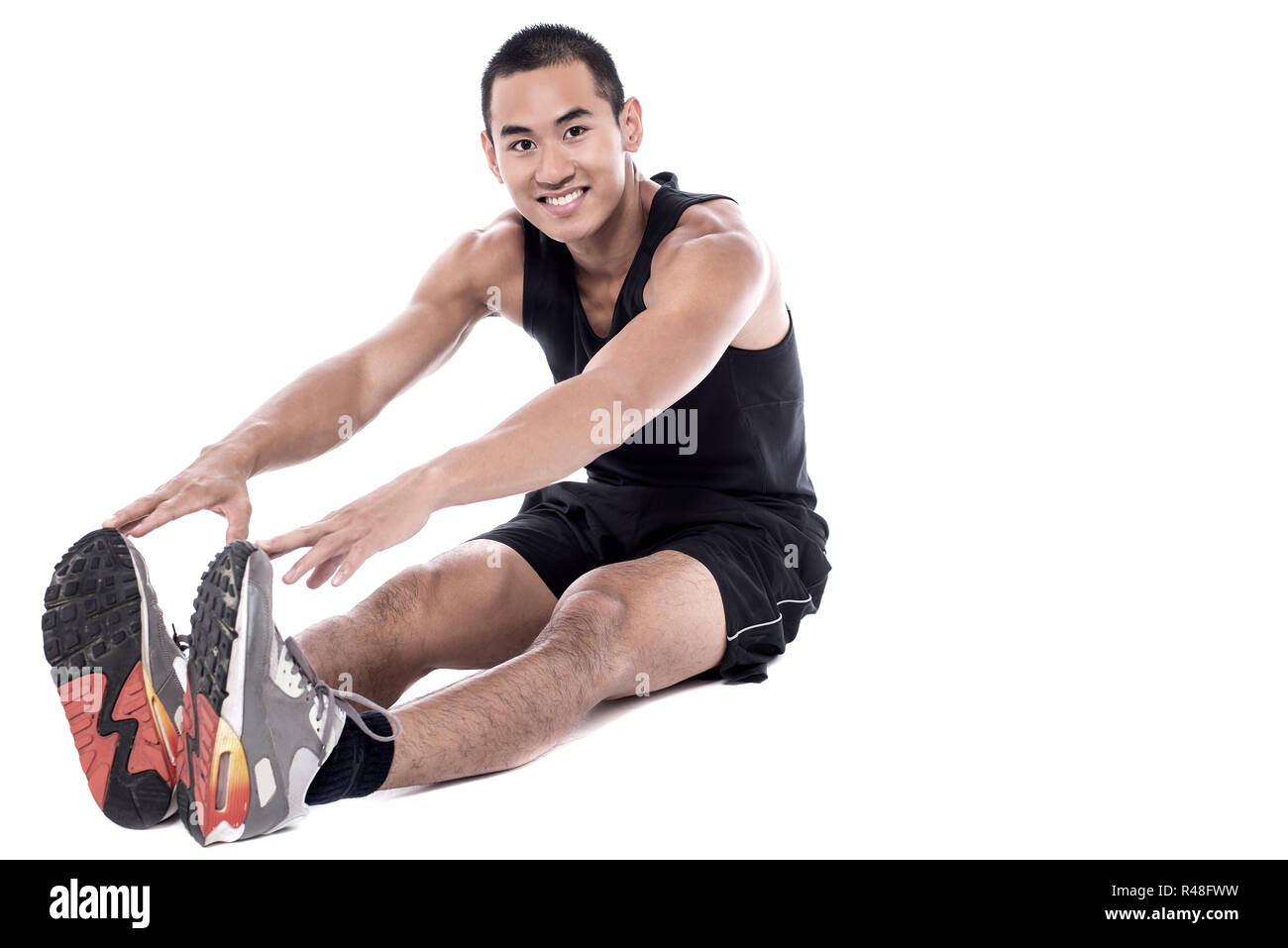 Fit guy doing stretching exercise Stock Photo - Alamy