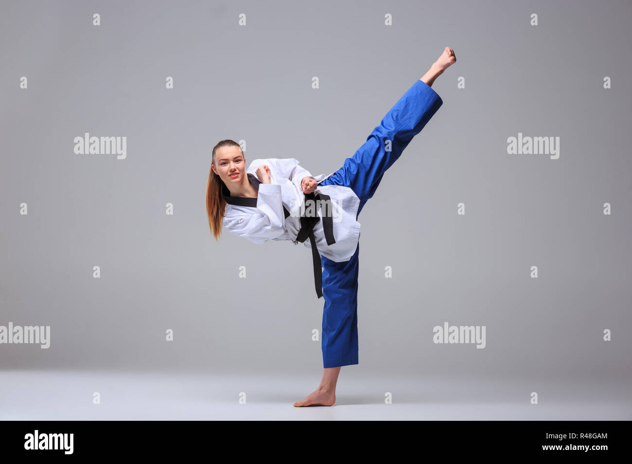 The karate girl with black belt Stock Photo - Alamy