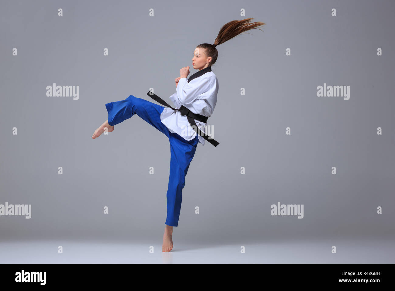 The karate girl with black belt Stock Photo - Alamy