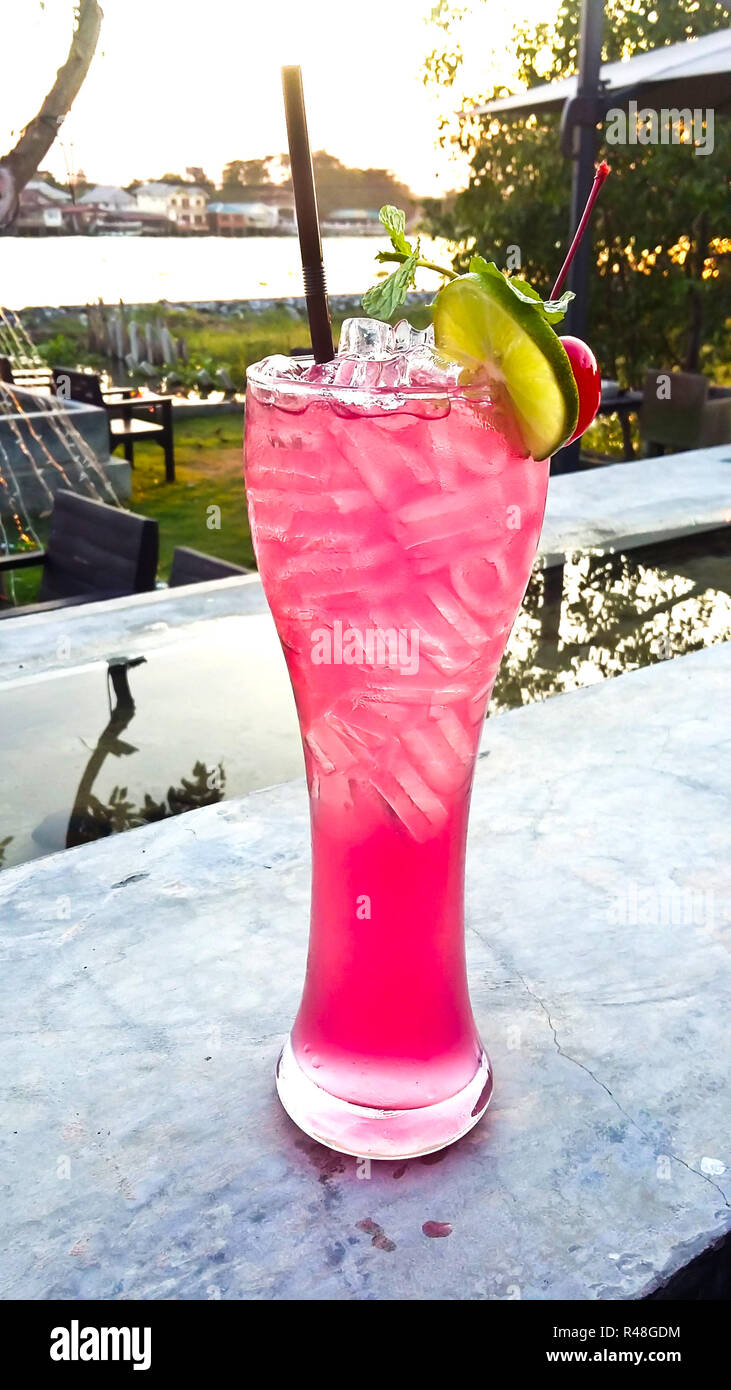 tropical pink cocktail Stock Photo - Alamy