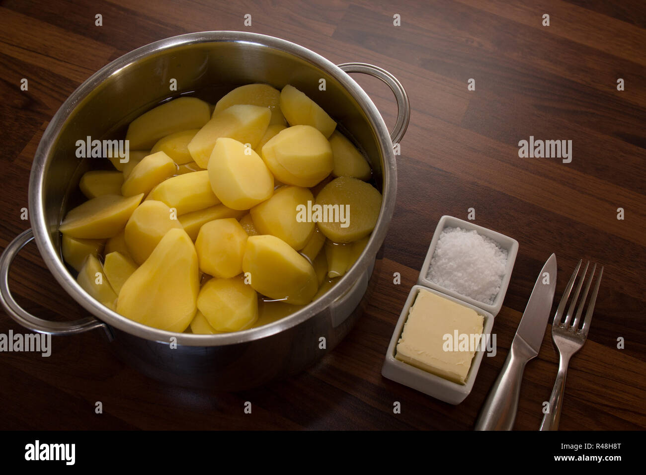 in a saucepan,silver,are freshly peeled potatoes in water. so the ...