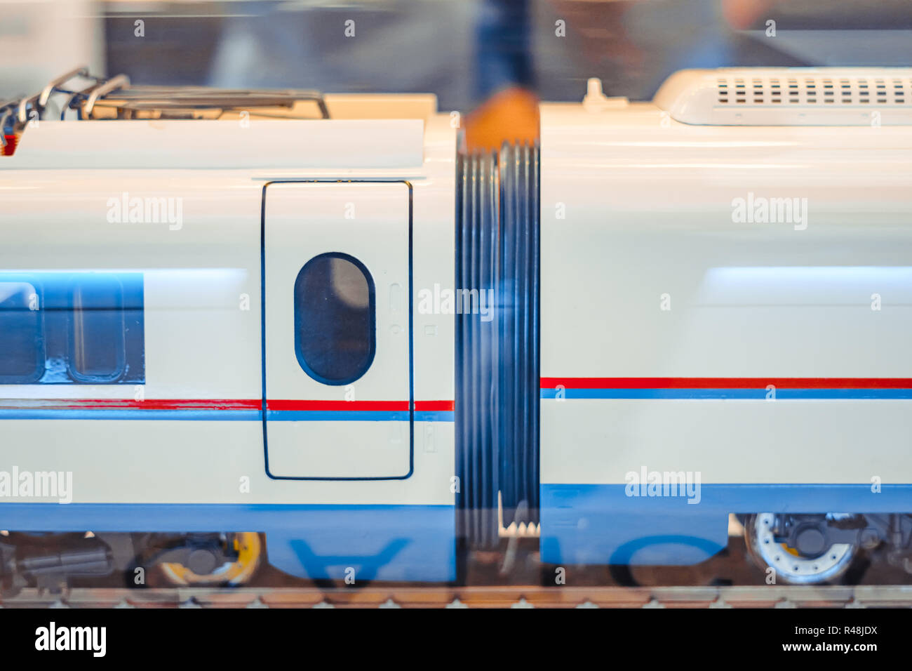 Miniature toy model of modern train crossing bridge Stock Photo - Alamy