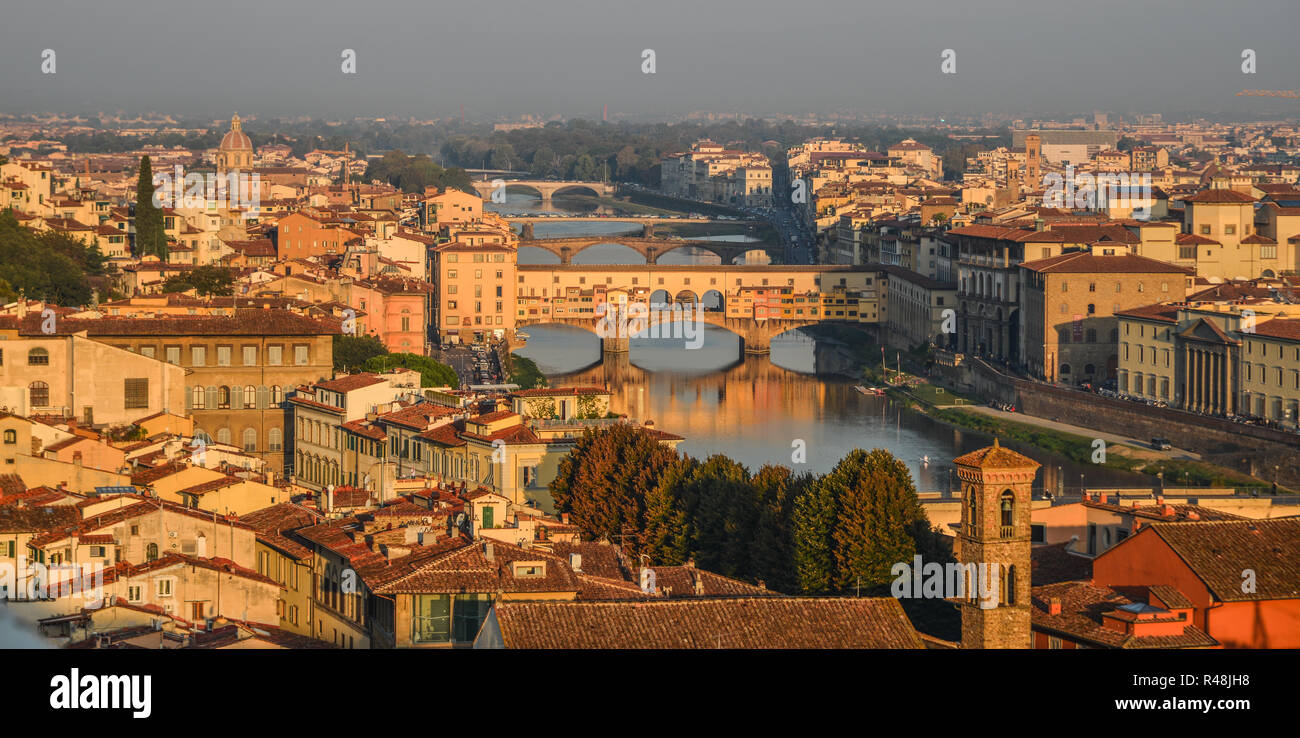 Aerial view of Ponte Vecchio with cityscape at sunrise in Florence ...