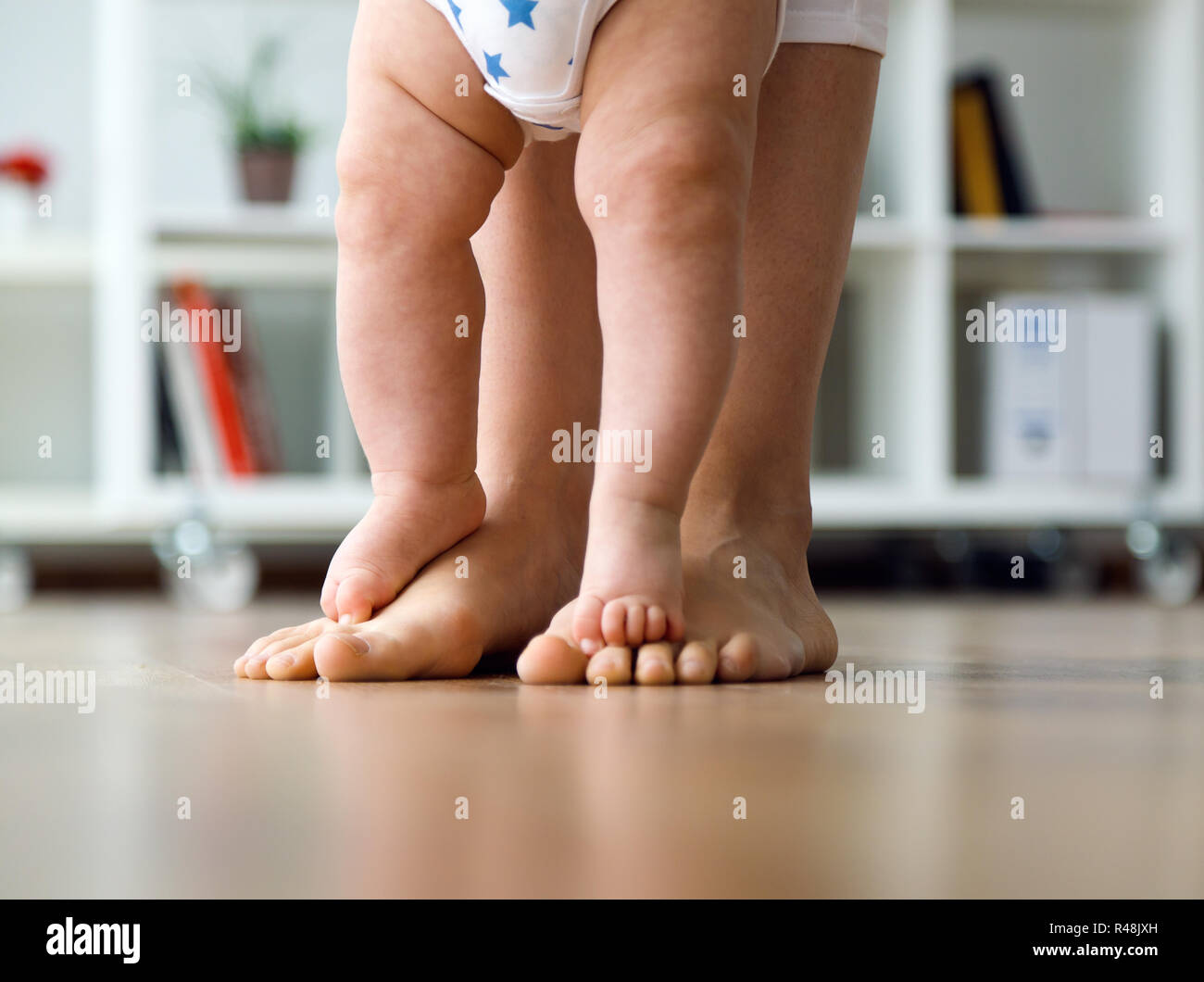 Mother and baby legs. First steps Stock Photo - Alamy