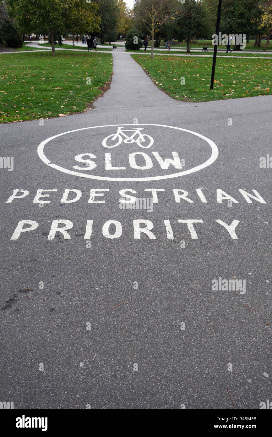 Slow - Pedestrian Priority sign on pathway Stock Photo - Alamy