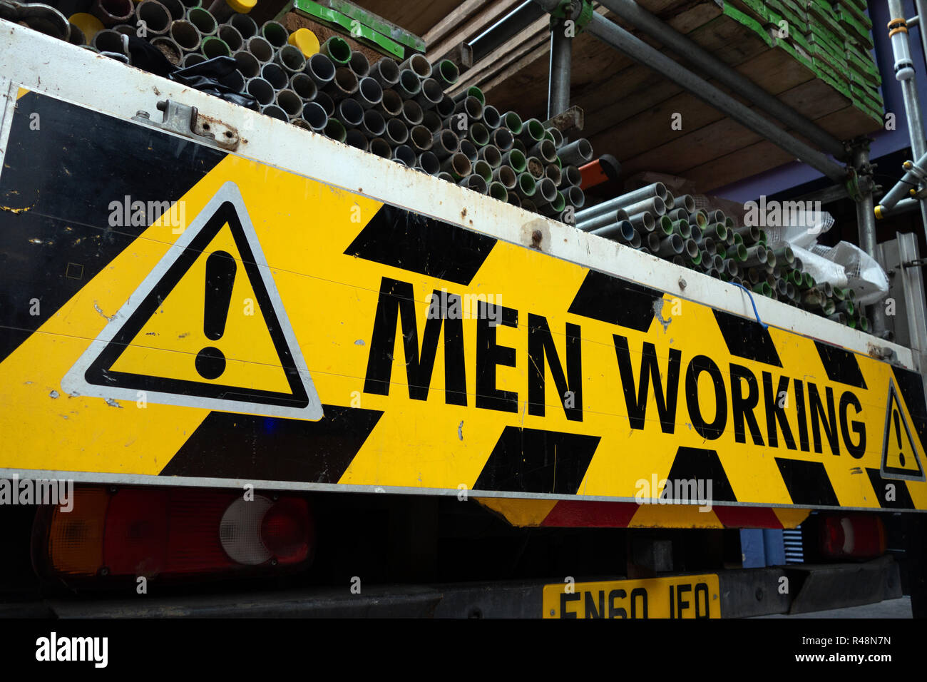 Men Working warning sign on the back of a Lorry in Soho, london Stock ...