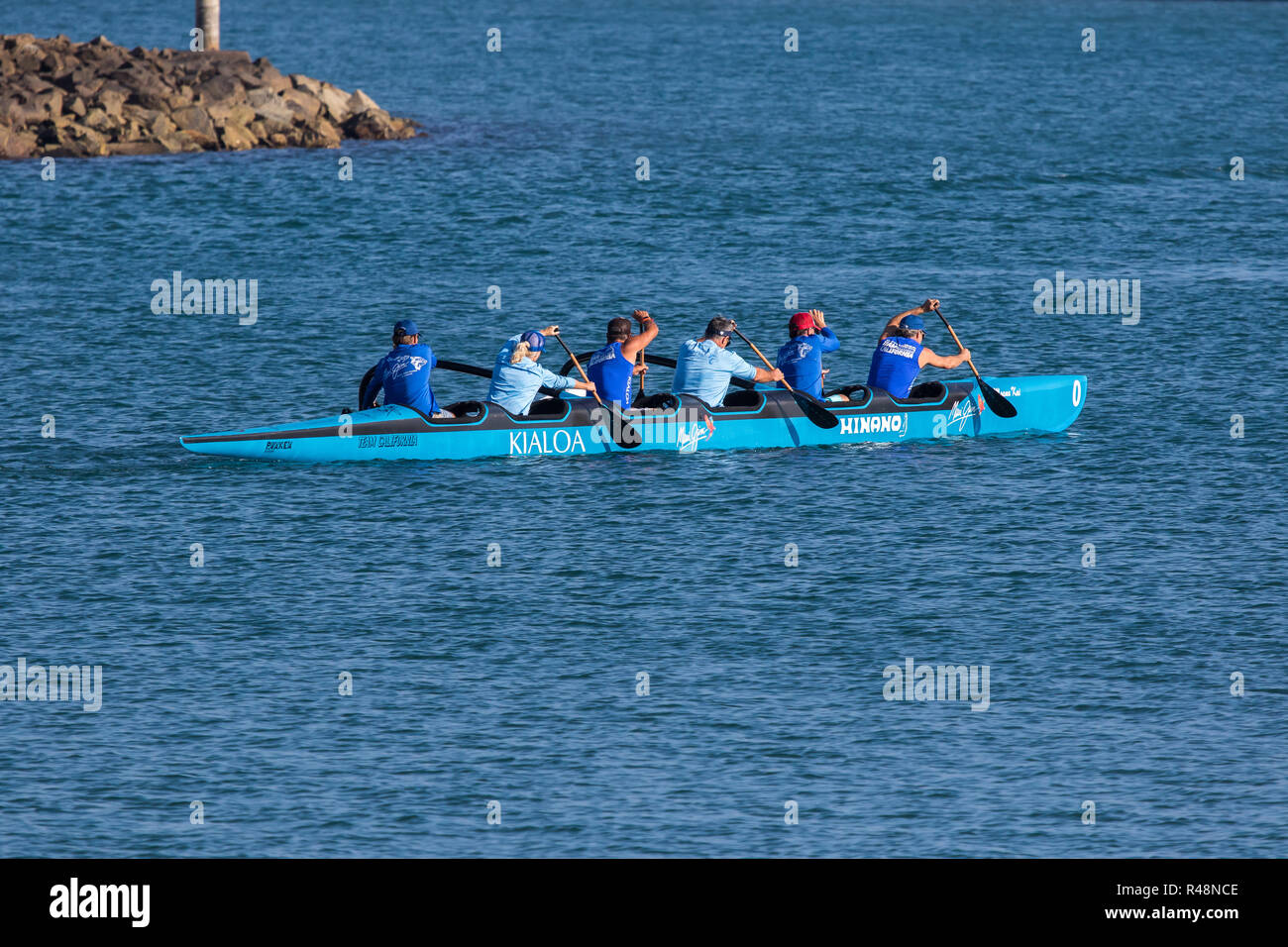 Outrigger canoe crew paddling inside the harbor at Dana point ...