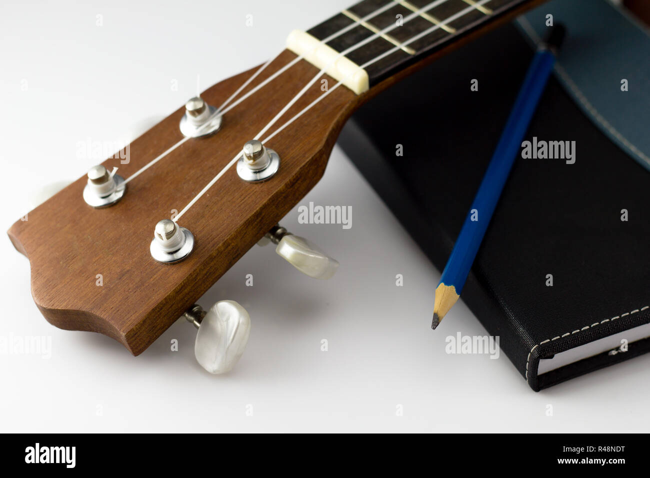 Notebook , pencil and Ukulele Stock Photo - Alamy