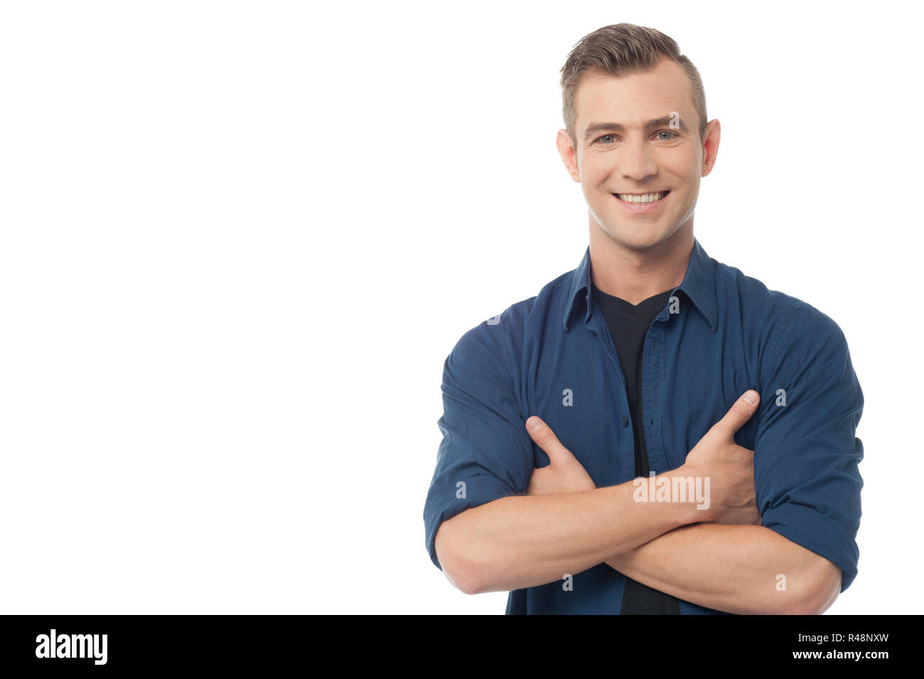 Happy guy with folded arms Stock Photo - Alamy