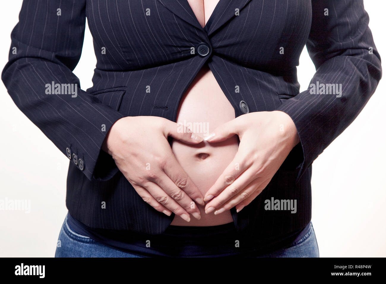 baby belly with hands heart Stock Photo - Alamy