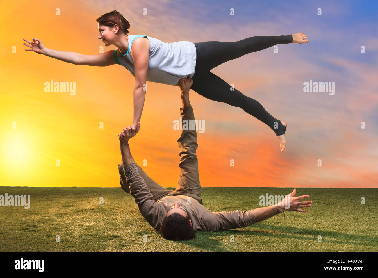 The two people doing yoga exercises Stock Photo - Alamy