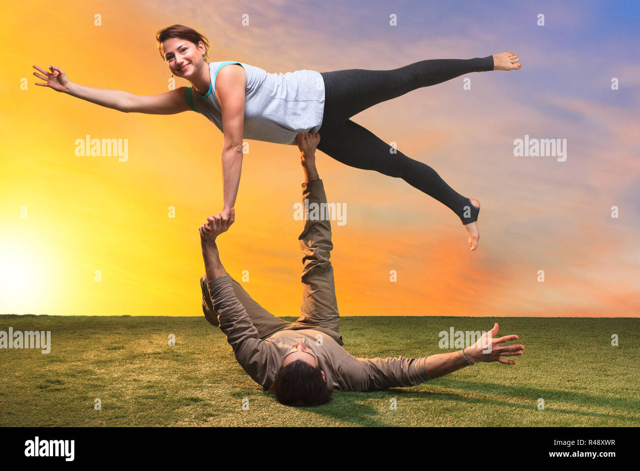 The two people doing yoga exercises Stock Photo - Alamy
