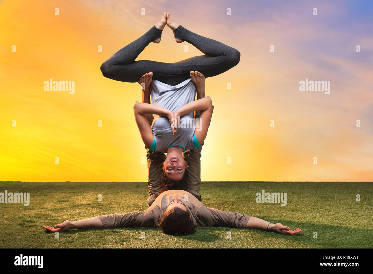 The two people doing yoga exercises Stock Photo - Alamy