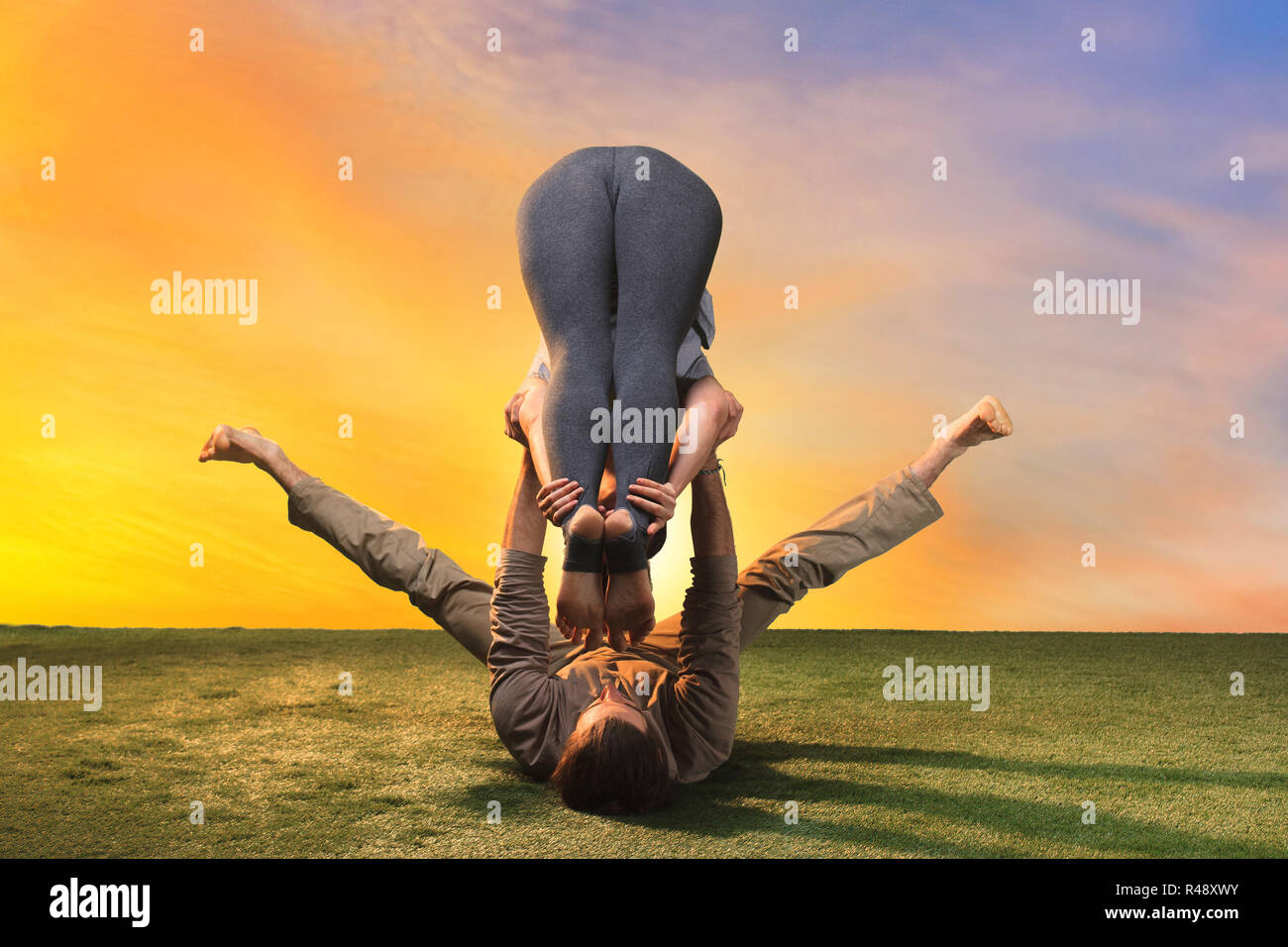 The two people doing yoga exercises Stock Photo - Alamy