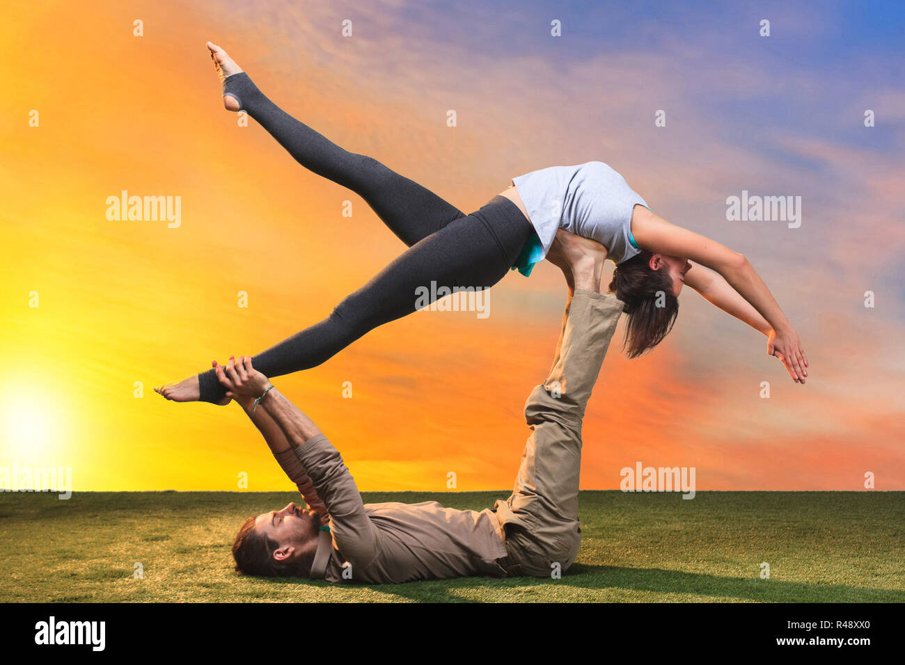 The two people doing yoga exercises Stock Photo - Alamy