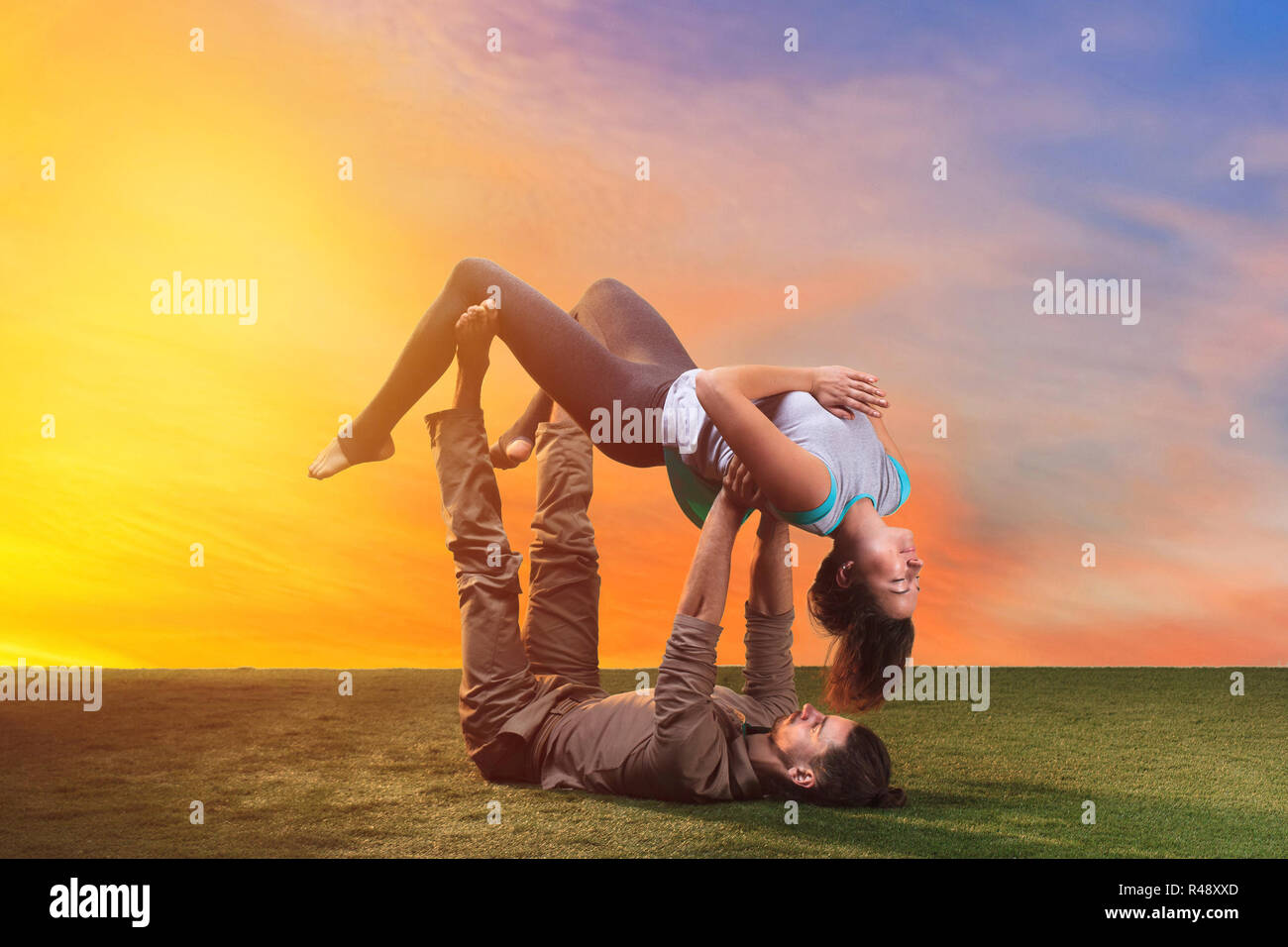 The two people doing yoga exercises Stock Photo - Alamy