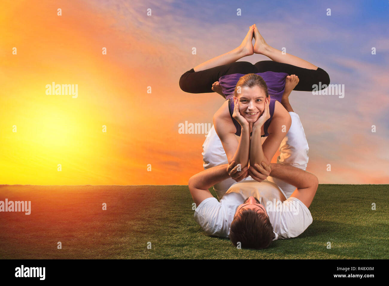 The two people doing yoga exercises Stock Photo - Alamy
