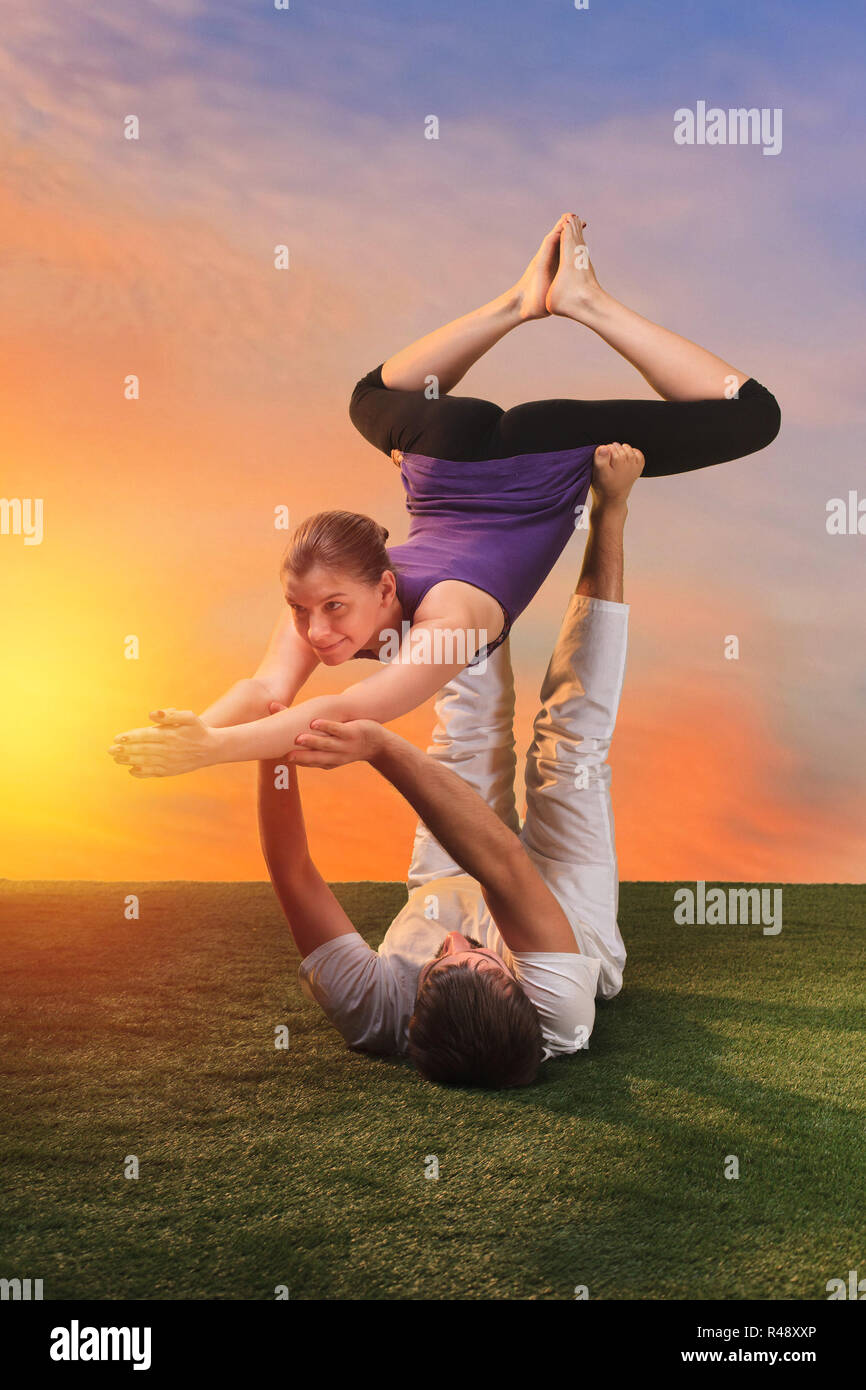 The two people doing yoga exercises Stock Photo - Alamy