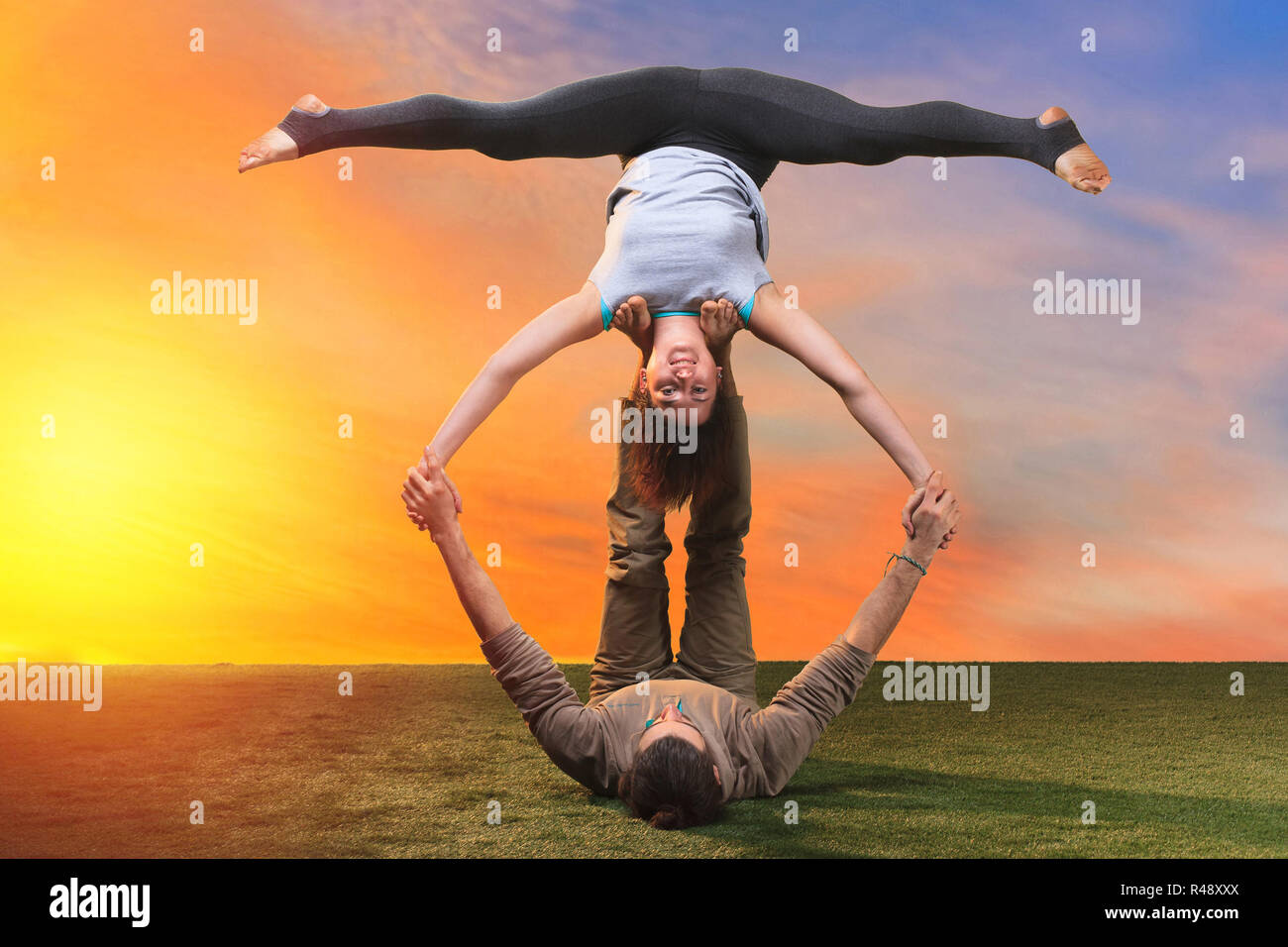 The two people doing yoga exercises Stock Photo - Alamy