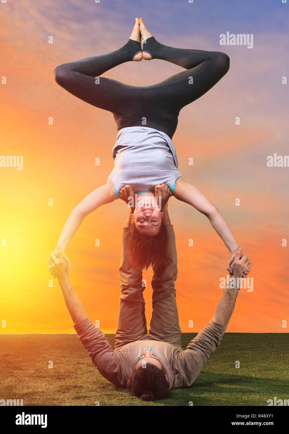 The two people doing yoga exercises Stock Photo - Alamy