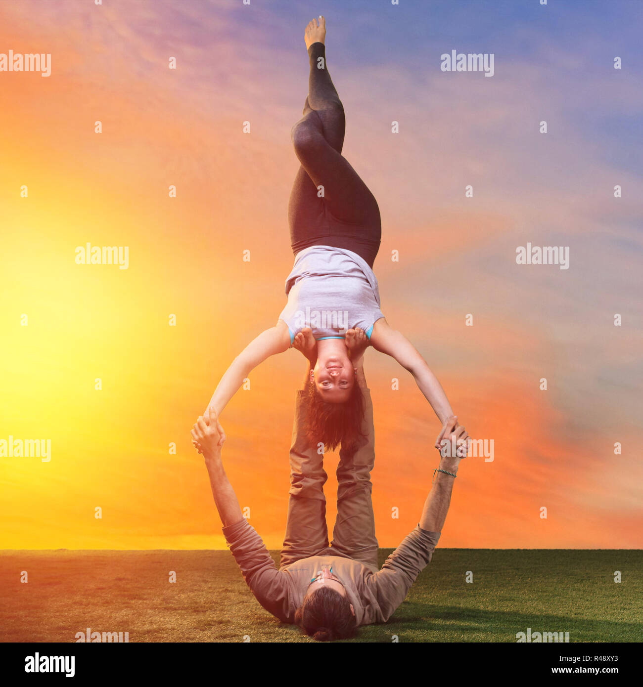 The two people doing yoga exercises Stock Photo - Alamy