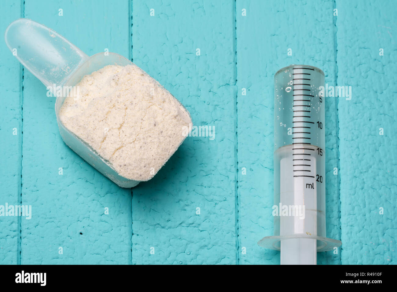 Container of milk whey protein and empty injection. Close-up. Blue ...