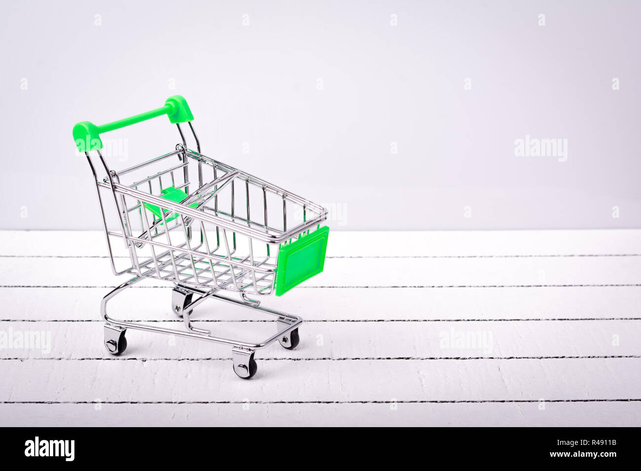 Little shopping cart on a white background Stock Photo - Alamy