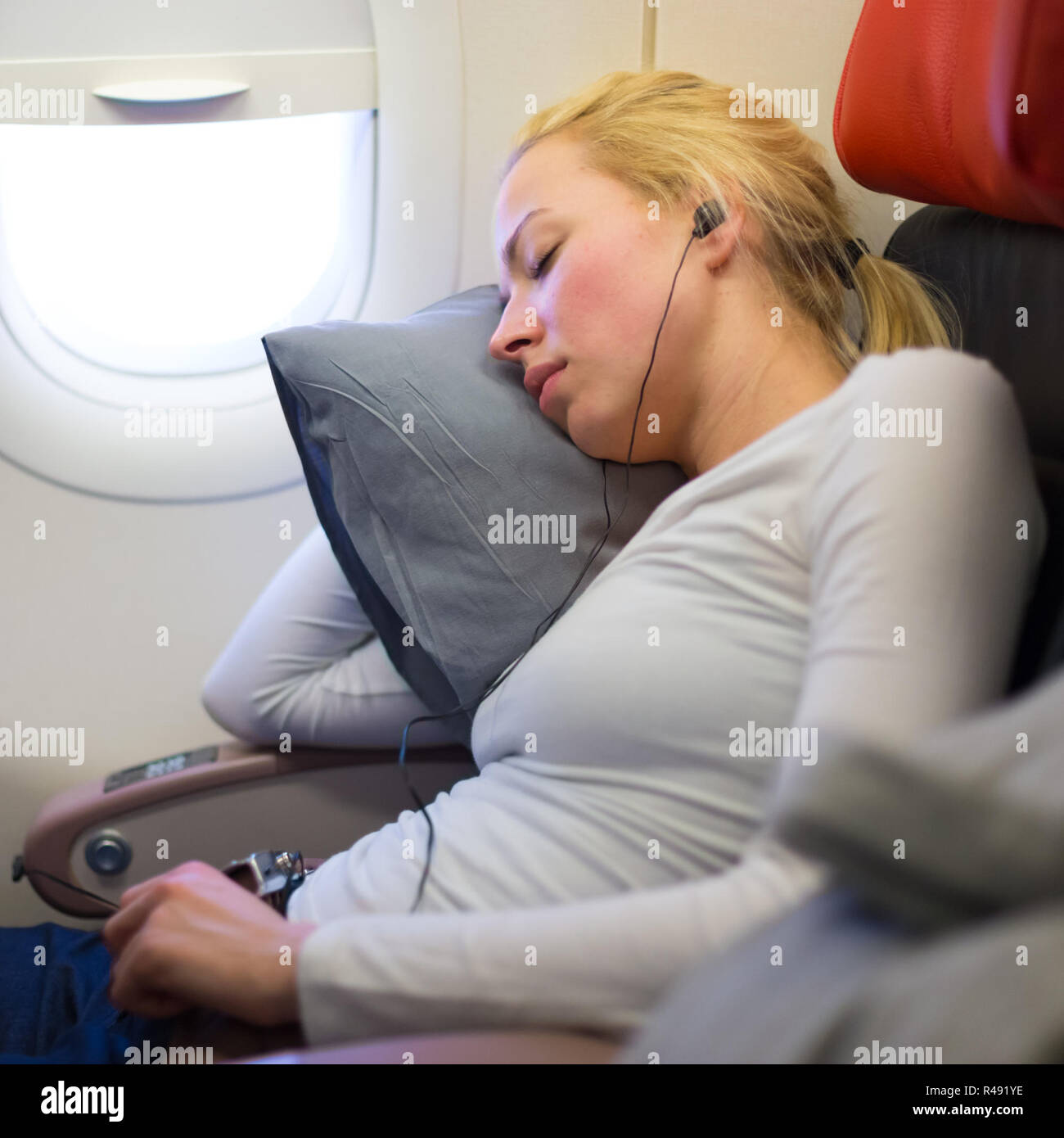 Woman on plane journey uncomfortable hi-res stock photography and ...