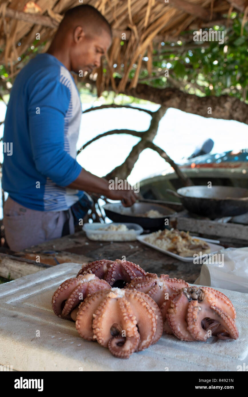 Colombian man cooking fresh octopus for the tourists. Daily life at the ...