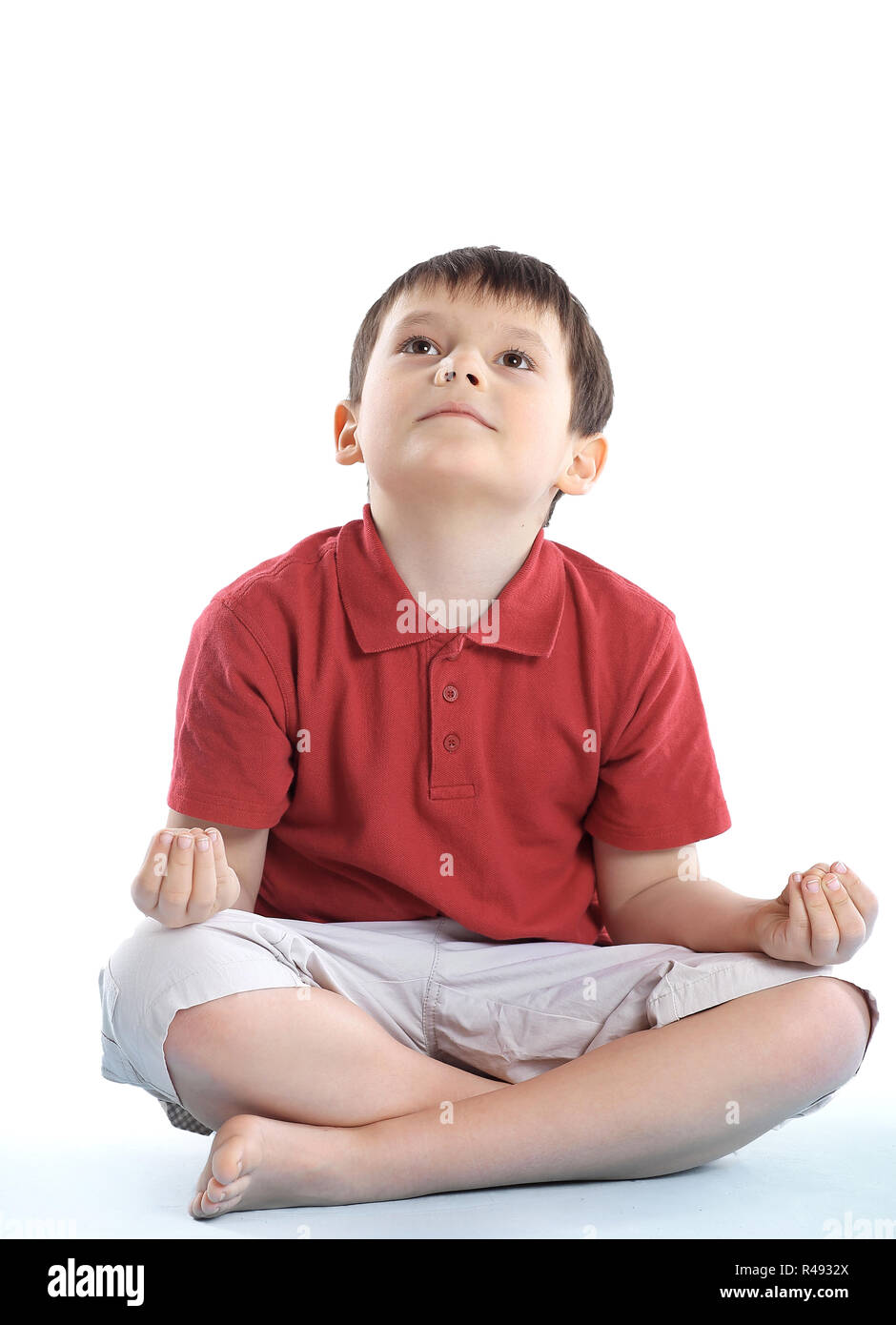 little boy is sitting in the Lotus position.isolated on white Stock ...