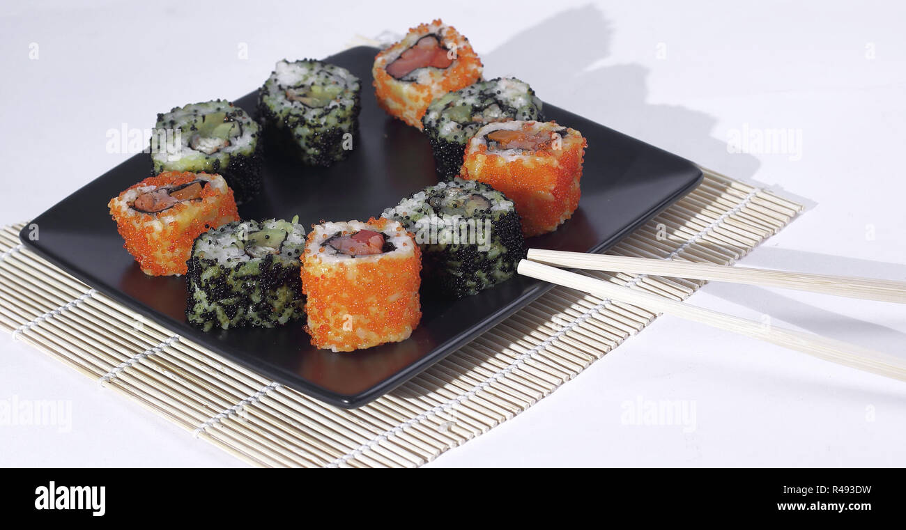 Sushi Set - different types of Maki sushi and chopsticks on a b Stock ...