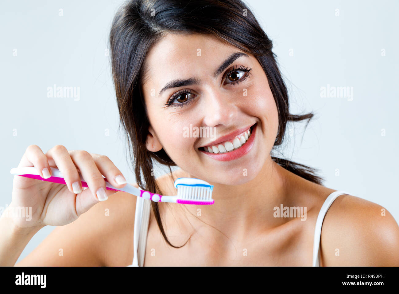 Beautiful young woman picking his teeth Stock Photo - Alamy