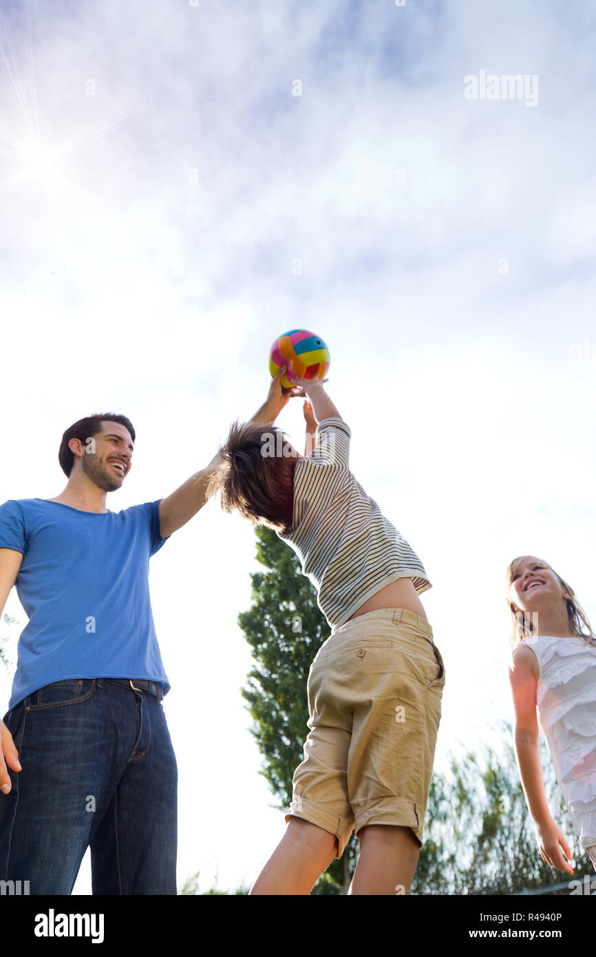 happy young family, father and son playing ball in the park Stock Photo ...