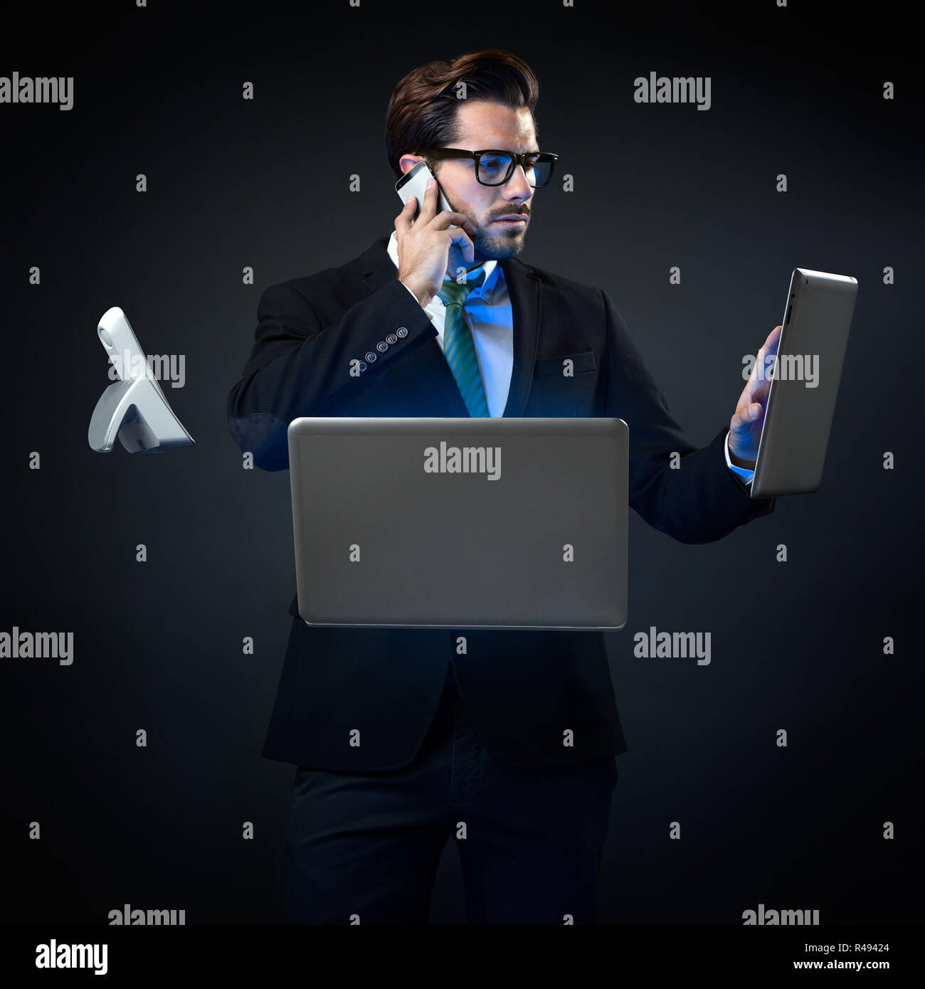 Stressed businessman talking on phone surrounded by technology Stock ...