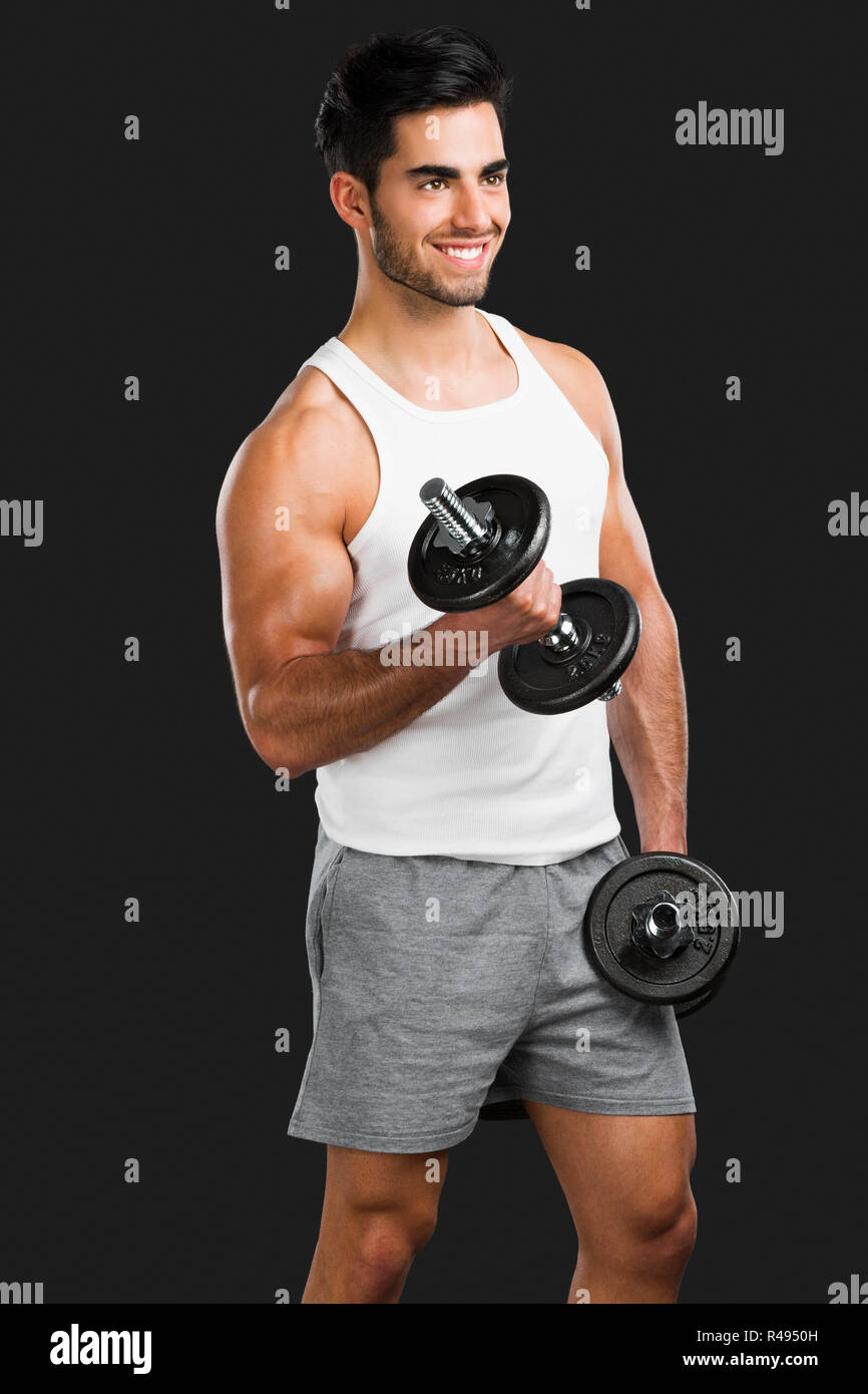 Athletic man lifting weights Stock Photo - Alamy