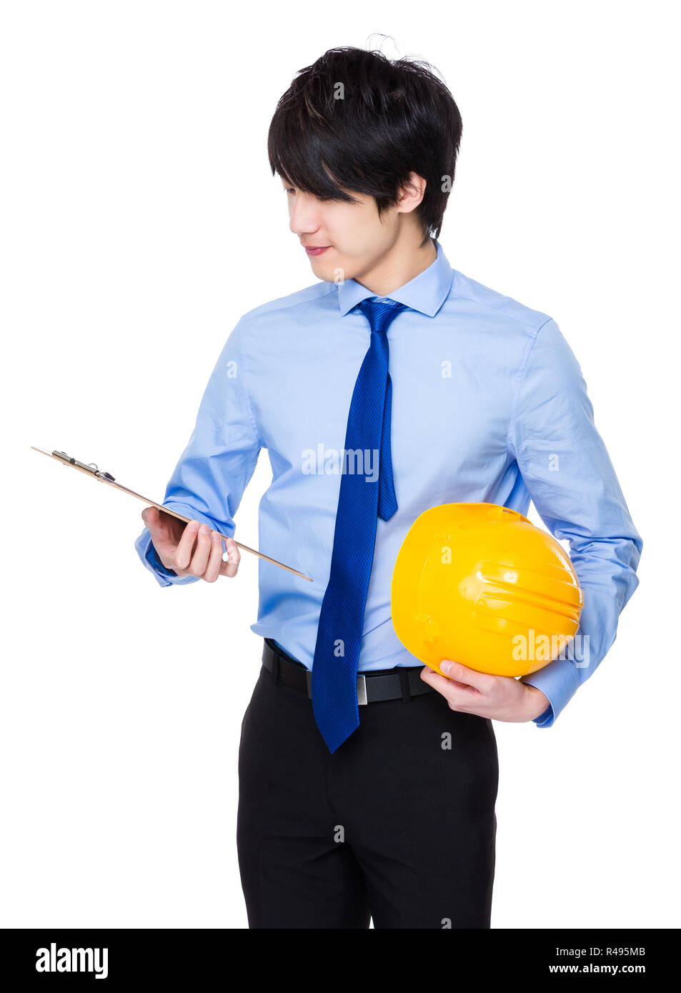 Young engineer hold with protective helmet and clipboard Stock Photo ...