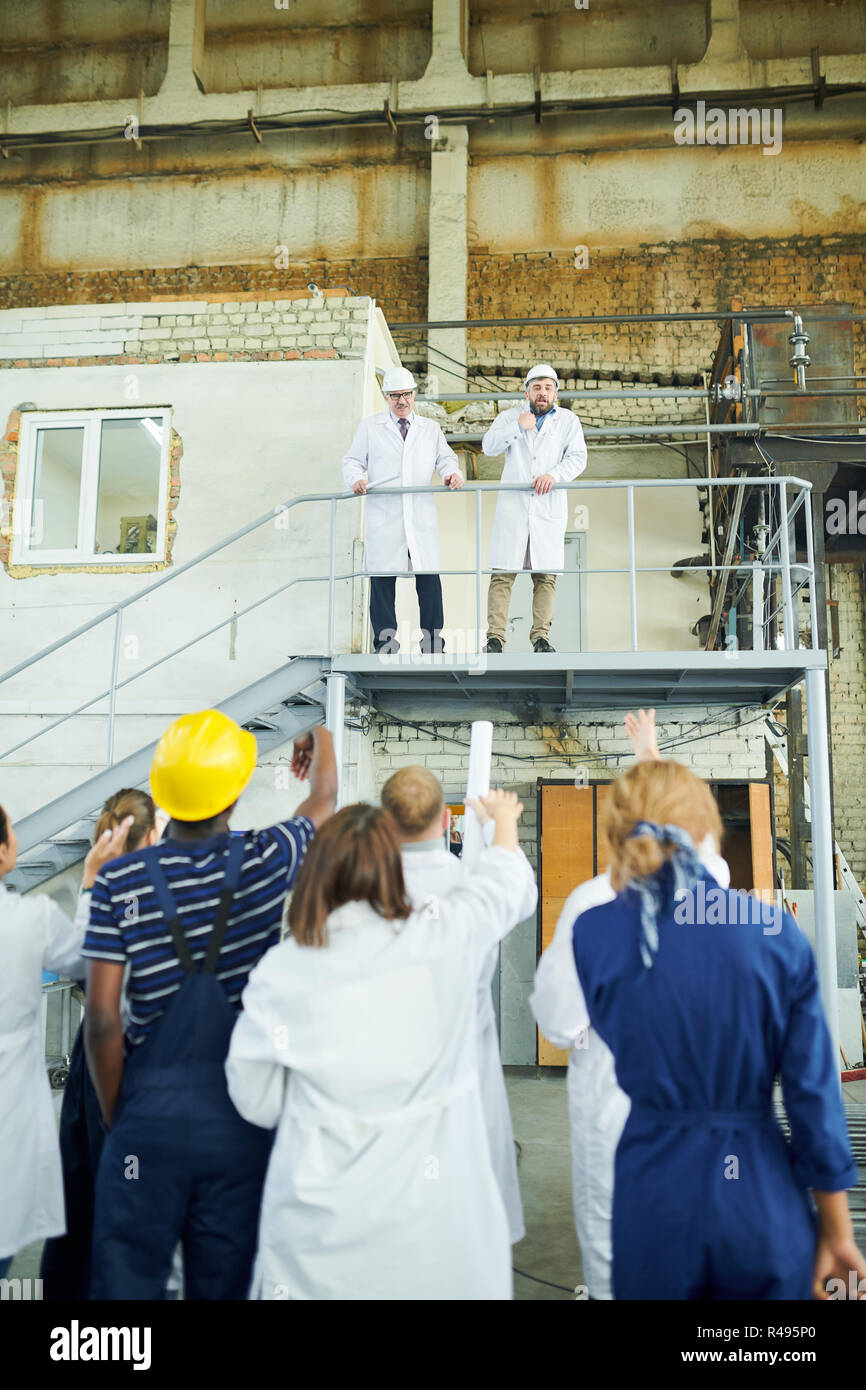 Two Factory Managers on Balcony Stock Photo - Alamy