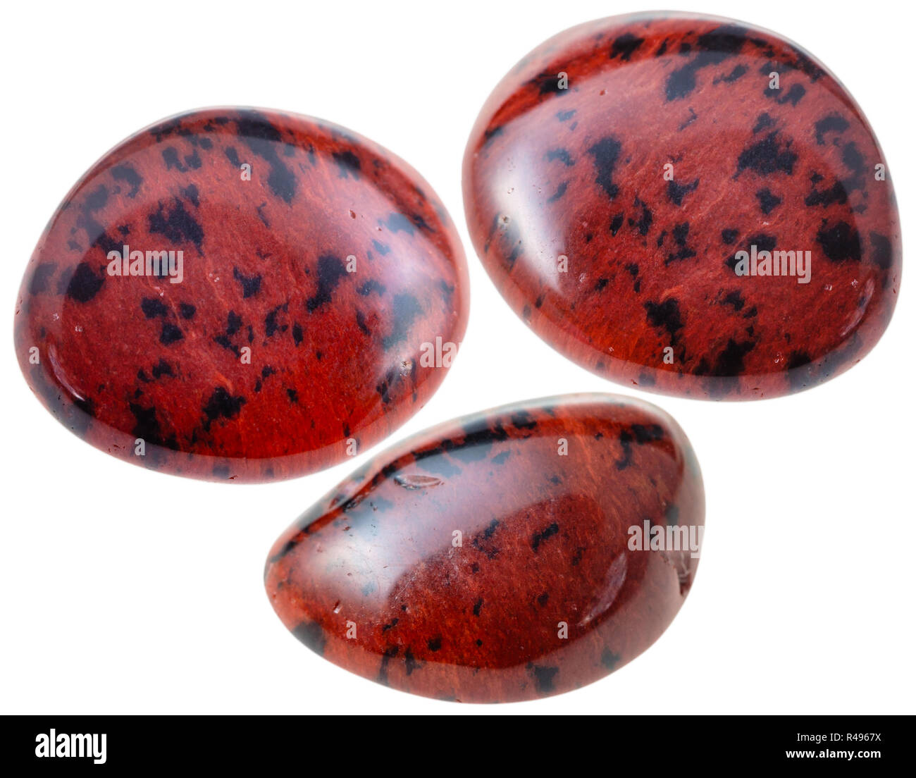 three Mahogany Obsidian gemstones isolated Stock Photo - Alamy