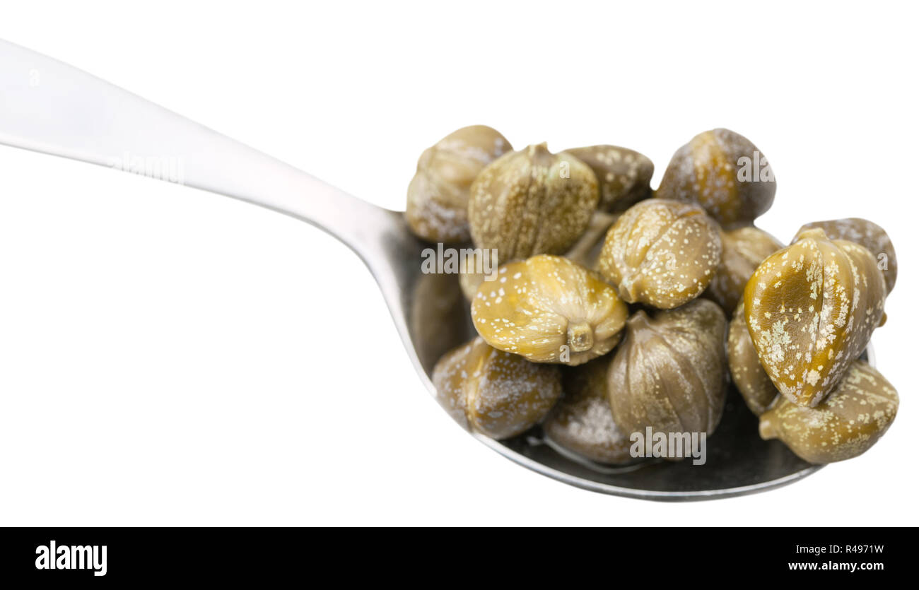 pickled capers in spoon close up isolated Stock Photo - Alamy