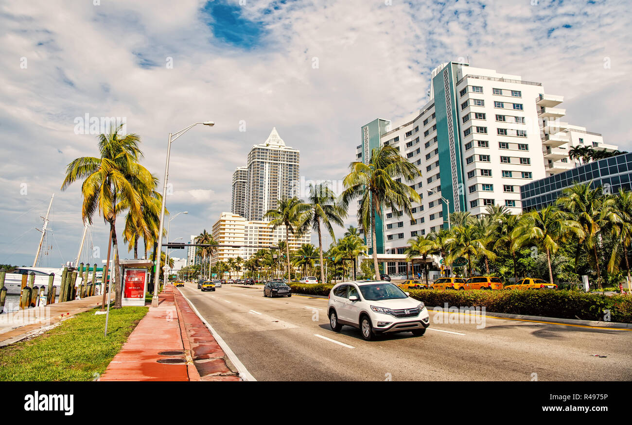 Miami, USA - January 10, 2016: cars driving on city road along sea ...