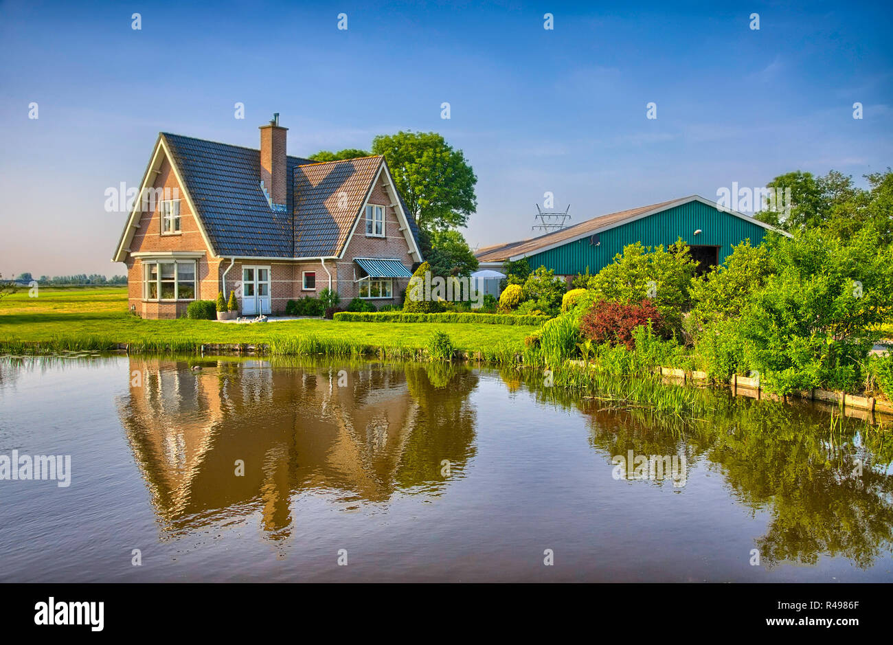 Red bricks house in countryside near the lake with mirror reflec Stock ...