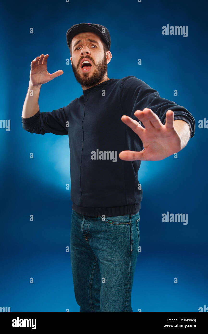 Young handsome man scared, shocked facial expression Stock Photo - Alamy