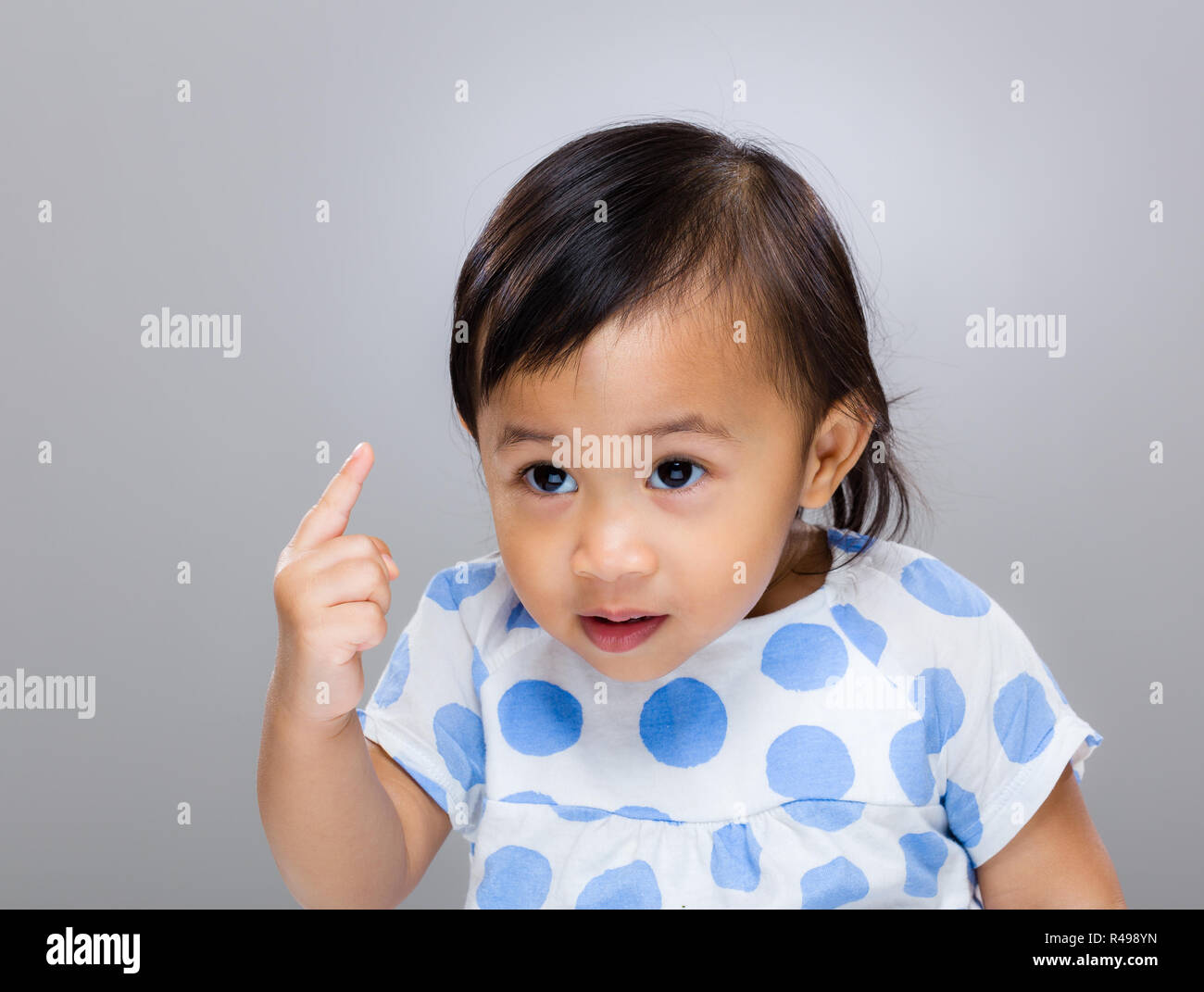 Baby girl frighten with finger Stock Photo - Alamy