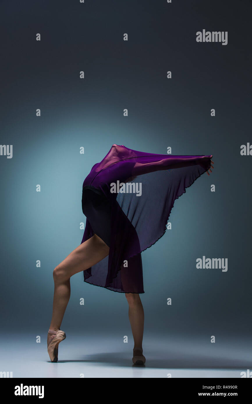 Young beautiful modern style dancer posing on a studio background Stock ...