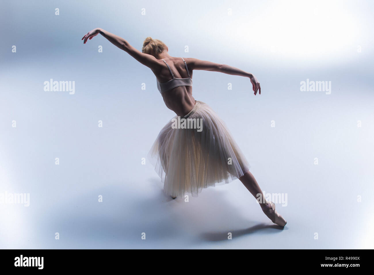 Young beautiful modern style dancer posing on a studio background Stock ...